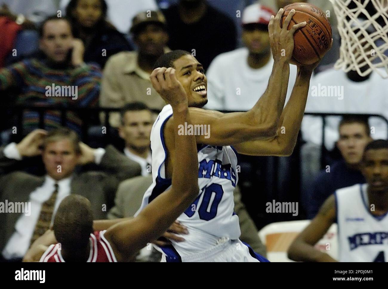 Memphis' Rodney Carney, middle, is fouled as he drives to the basket ...
