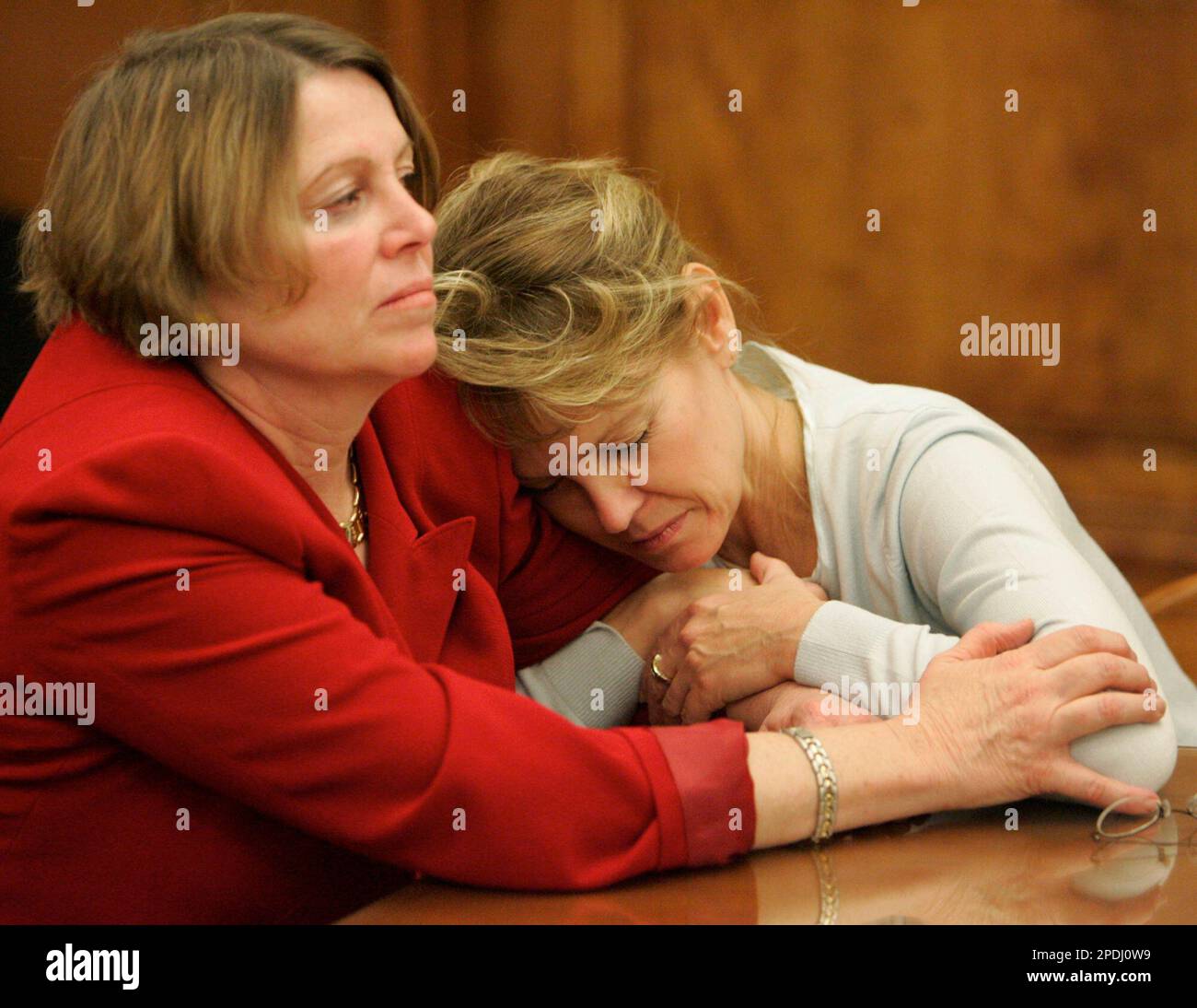 Defense attorney Pat Millhoff, left, comforts Cynthia George, Monday ...