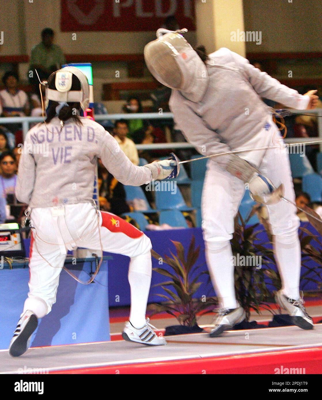 Nguyen Vie of Vietnam left, makes a score against her Filipino opponent ...