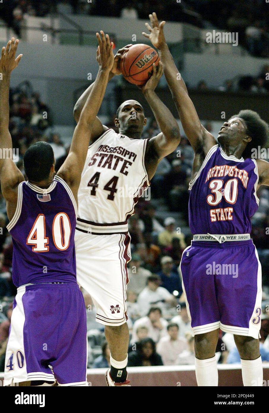 Northwestern State's Alfonse Dyer (40) and Clifton Lee (30) try to ...
