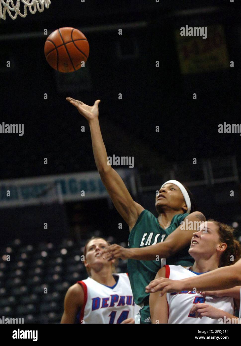 Eastern Michigan's Patrice McKinney, center, goes up against DePaul's ...