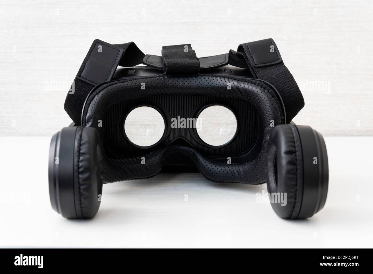 Virtual reality helmet on white background table. Black modern glasses ...