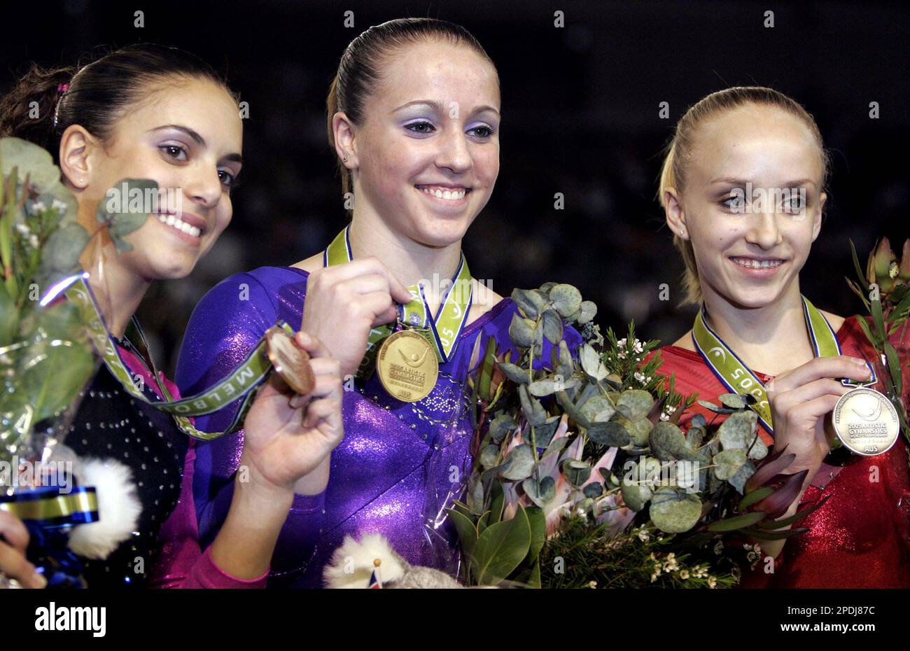 Gold medalist Chellsie Memmel of the U.S., center, stands with ...