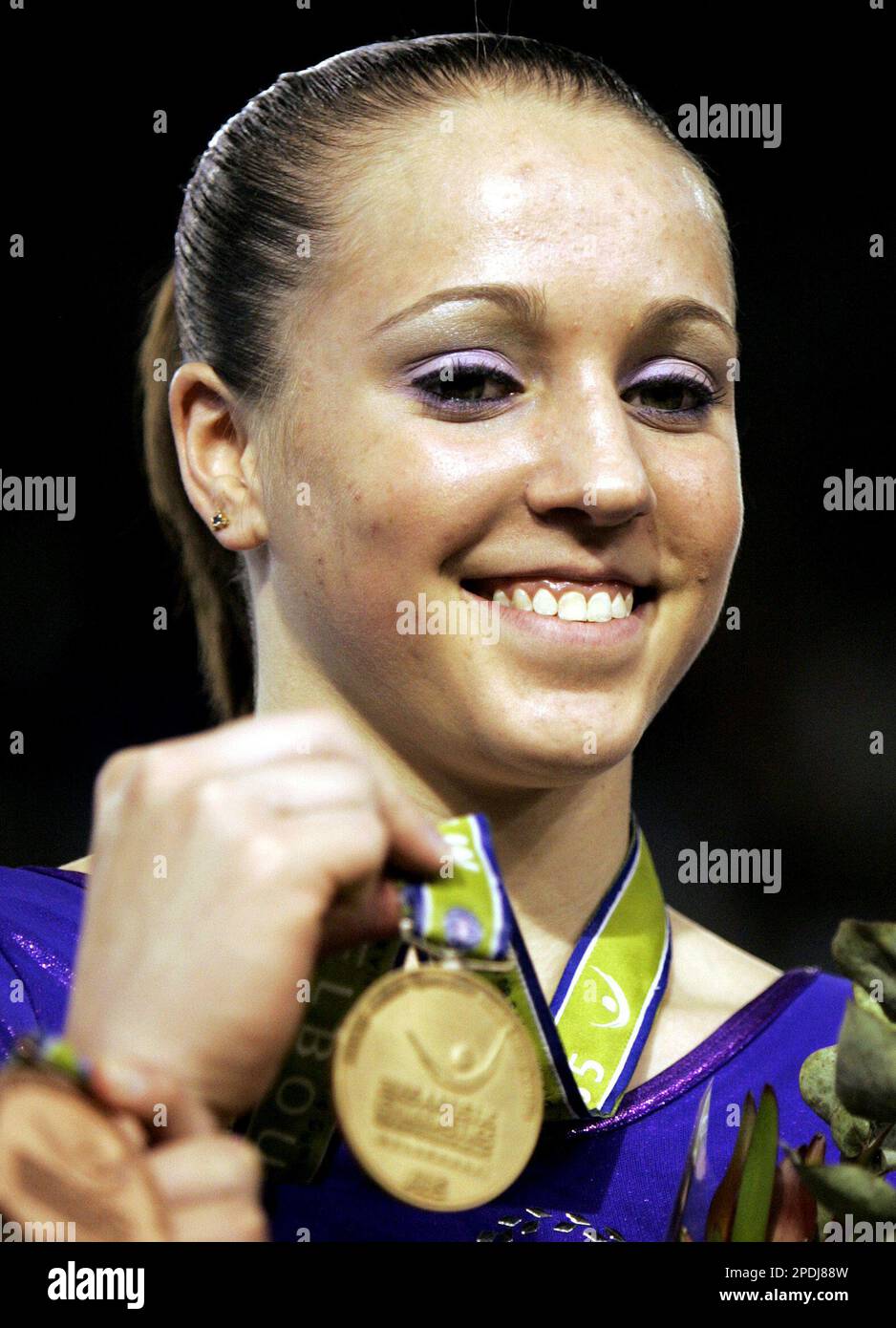 Chellsie Memmel of the U.S. holds her gold medal up after winning the ...