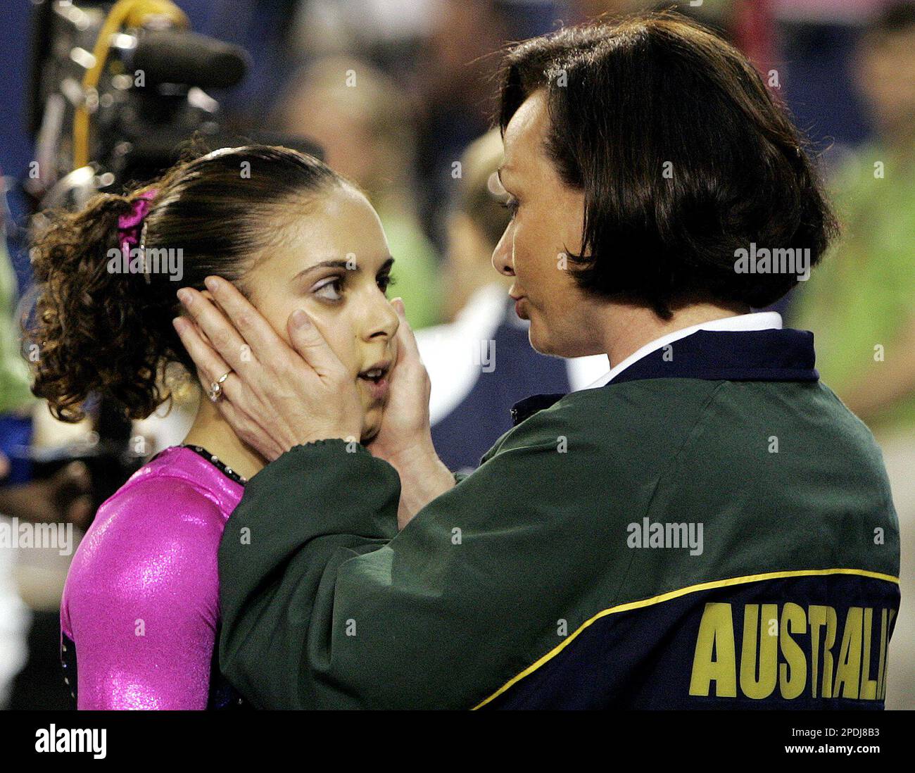 Australia's Monette Russo is embraced by Australian coach Peggy Liddick ...