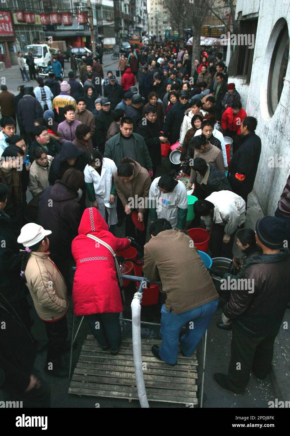 Residents fill water containers from a truck in Harbin, in northeast ...