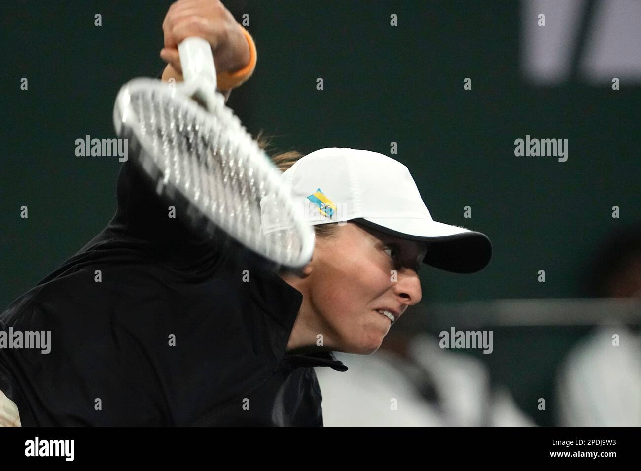 Iga Swiatek, of Poland, serves to Emma Raducanu, of Britain, at the BNP ...