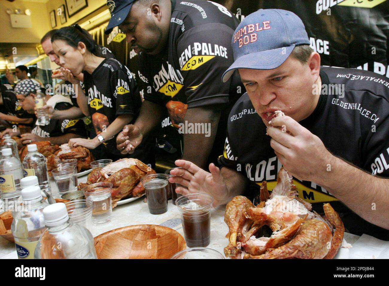 Bob Shoudt, 39, of Royersford, Pa., right, eats his turkey as he ...