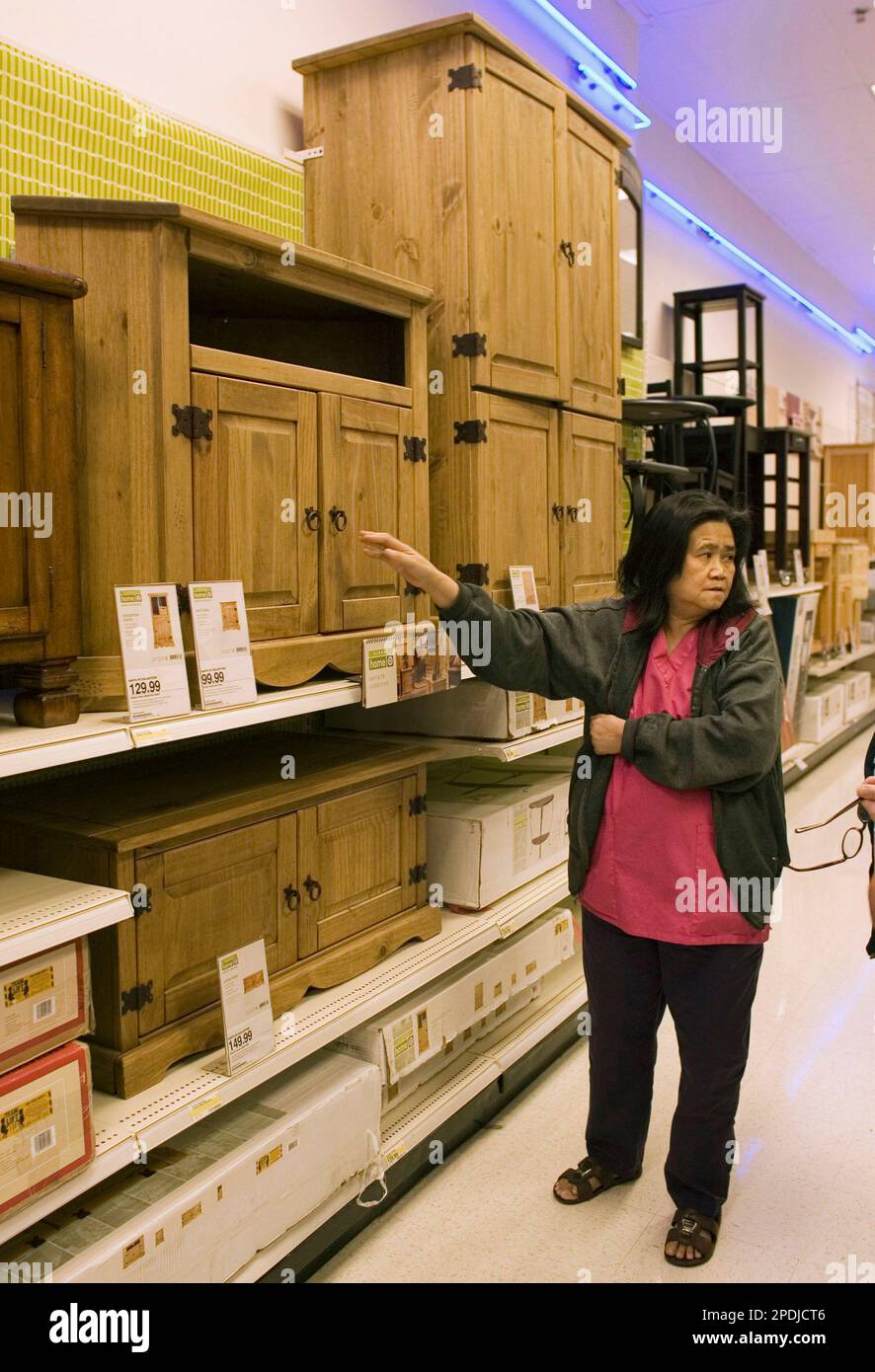 Leonida Onchango shops for an entertainment center at a Target store in ...