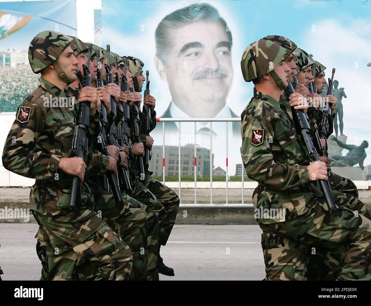 Lebanese soldiers march in front of a portrait of slain former Lebanese ...