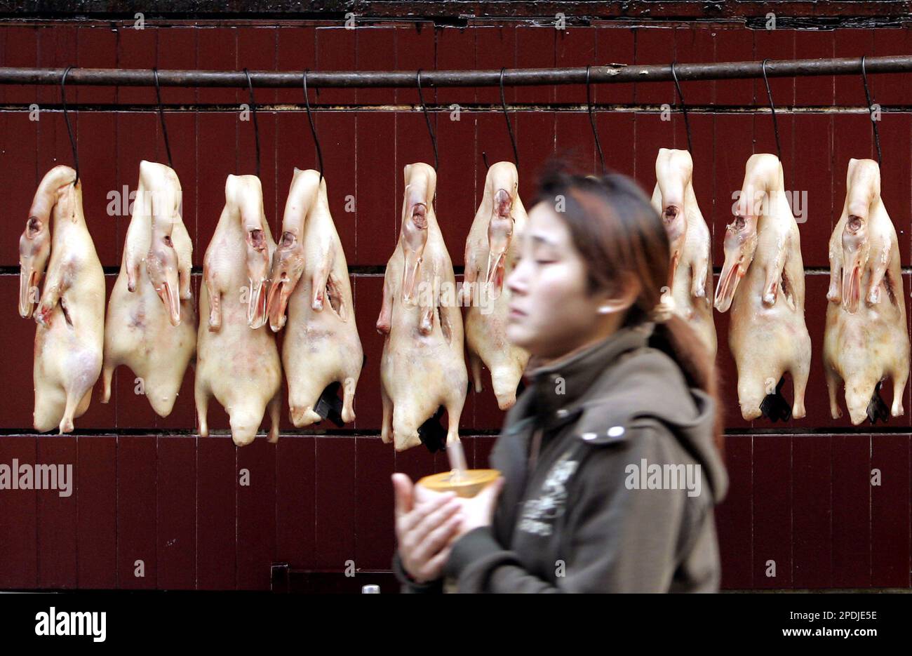 Ducks are hung to dry in the shade for one of the most famous Chinese ...