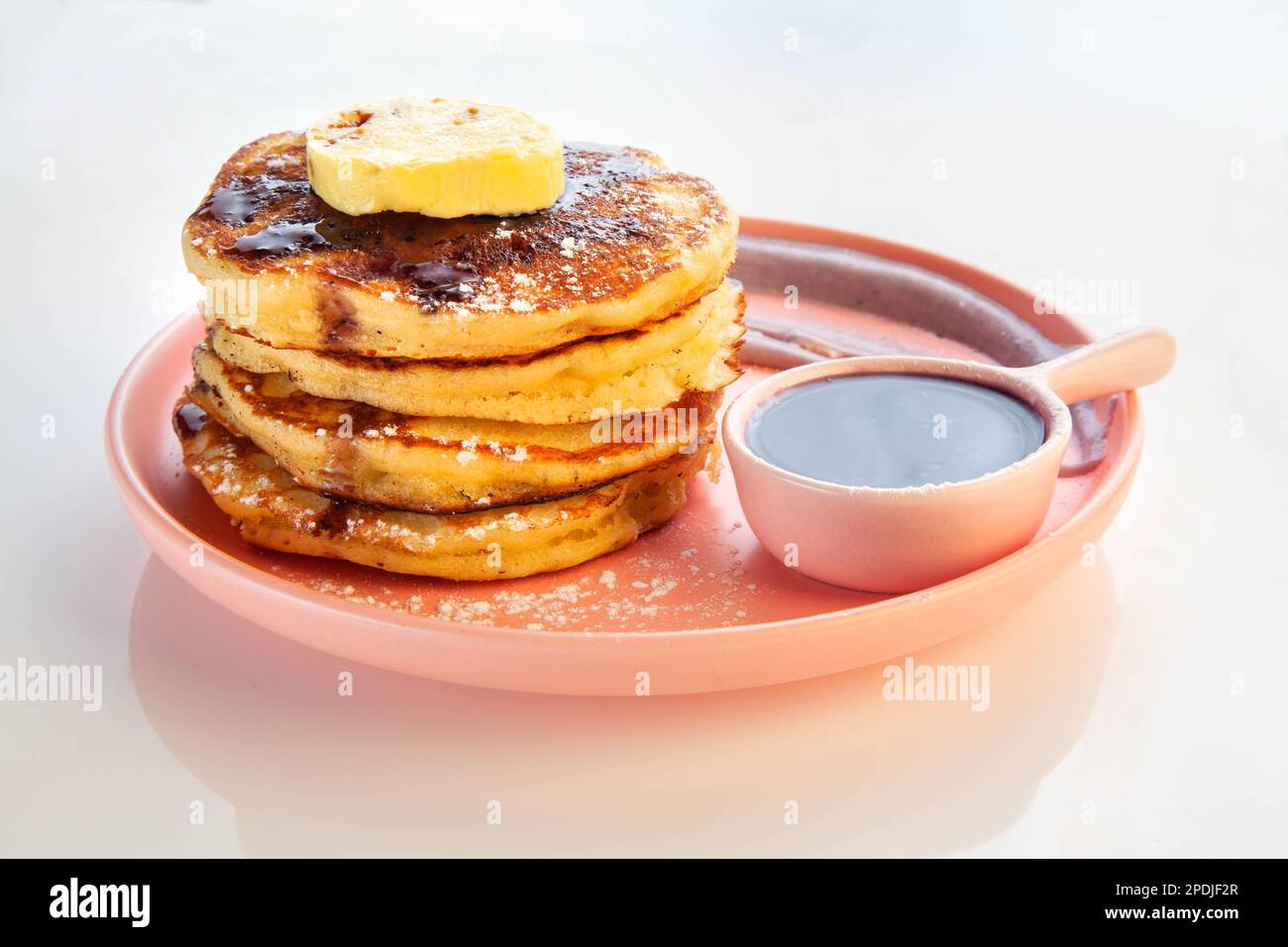 Stack of blue berry pancakes topped with honeycomb butter and maple ...