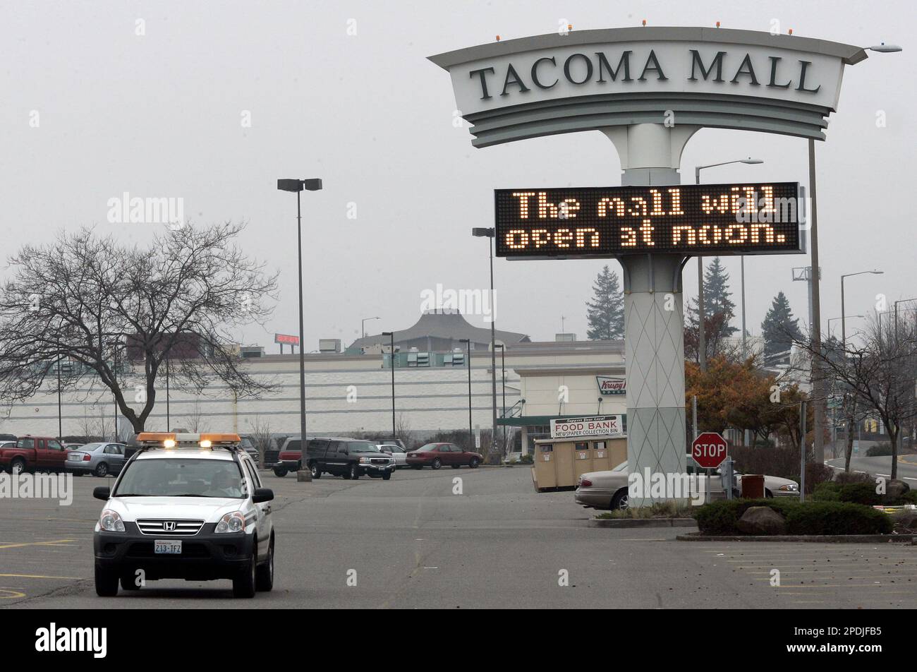 A mall security car drives past a sign announcing that the Tacoma Mall ...