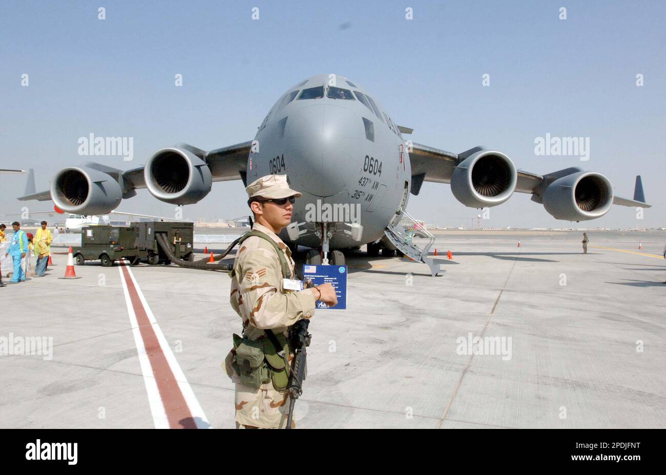 A U. S. soldier guards a heavy duty transport aicraft at the Dubai Air ...