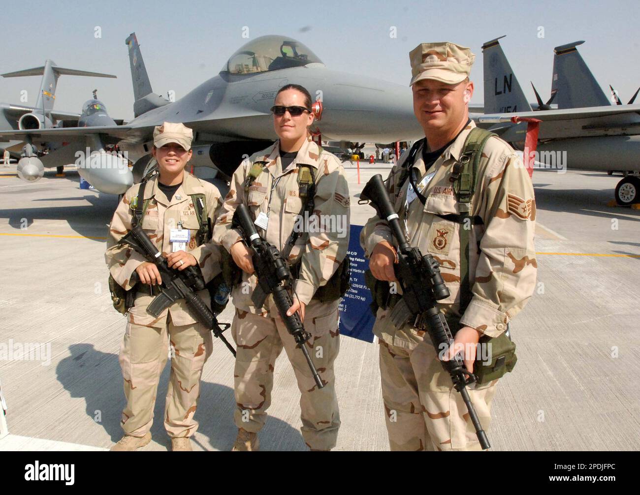 U.S. Army personnel guard a F-16 aircraft during the Dubai Air Show ...