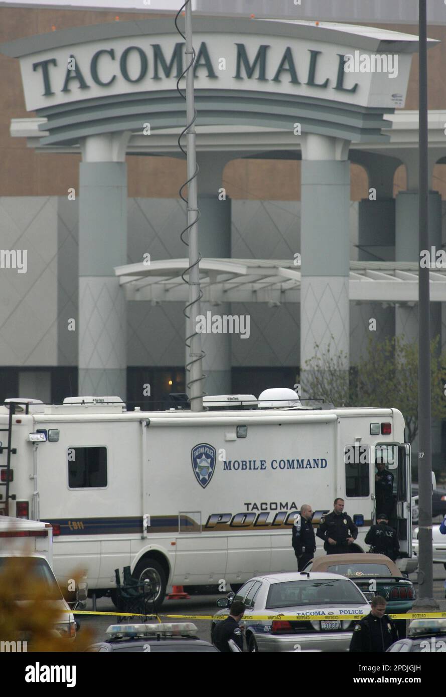 Police stand near a mobile command center at the Tacoma Mall Sunday ...