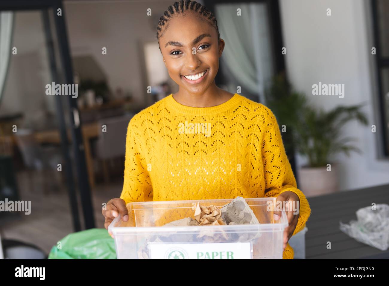 Cute woman holding bin hi-res stock photography and images - Alamy