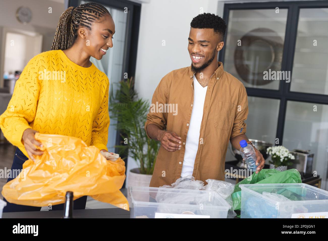 Happy african american couple segregating waste in kitchen Stock Photo ...