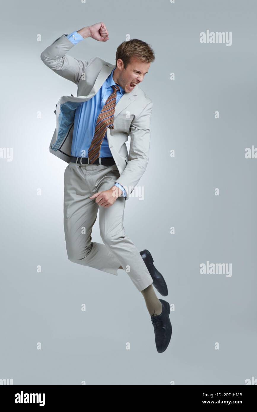 He cannot contain his excitement. a young businessman wildly ...