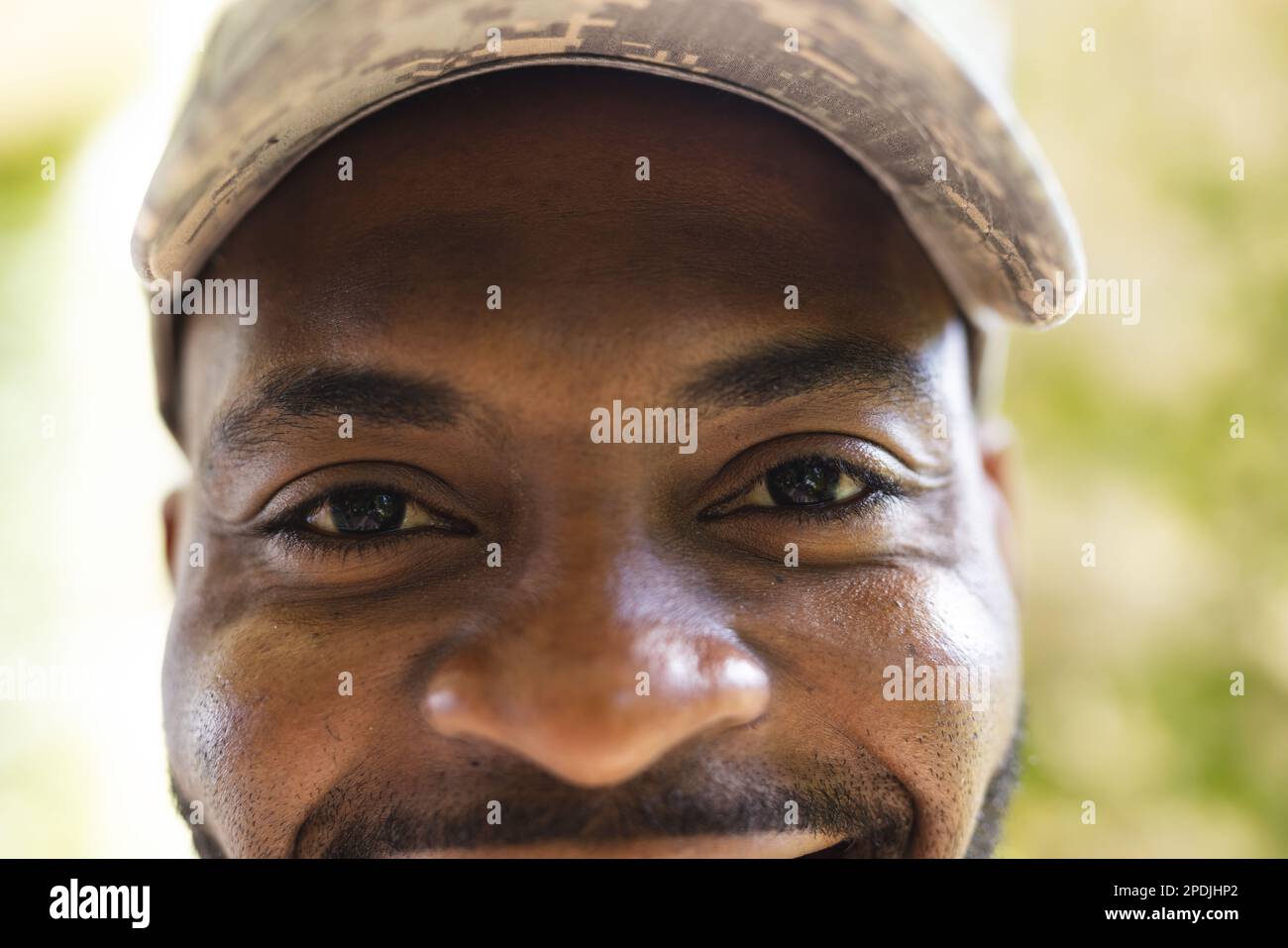 Portrait of happy african american male soldier looking at camera and ...