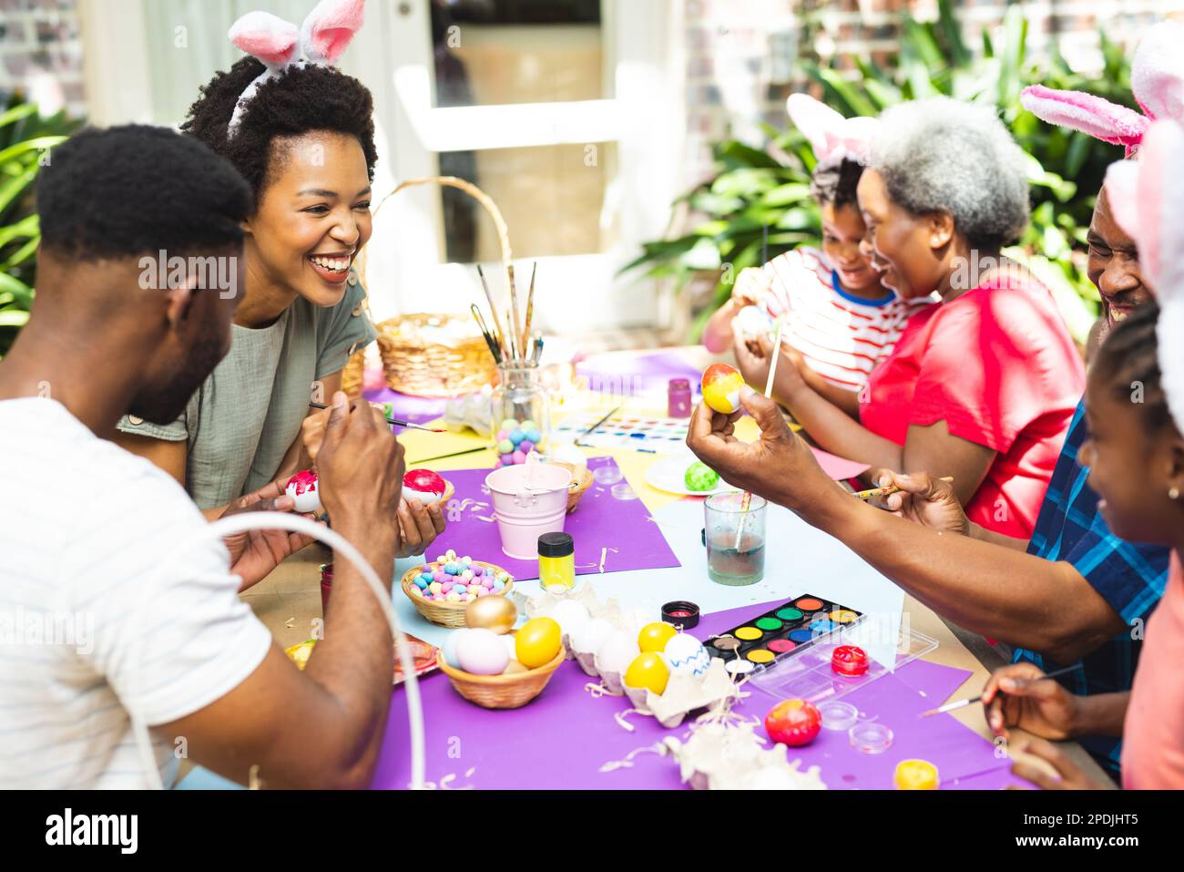 Happy african american family coloring easter eggs in garden Stock ...