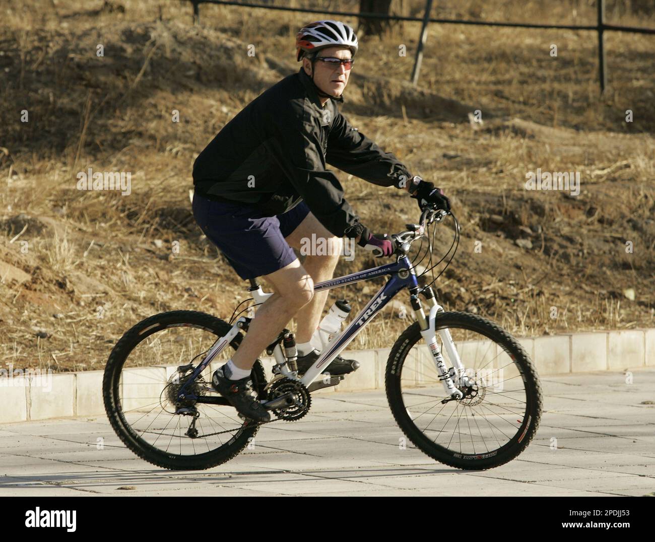 U.S. President George W. Bush rides his mountain bike at the Laoshan ...