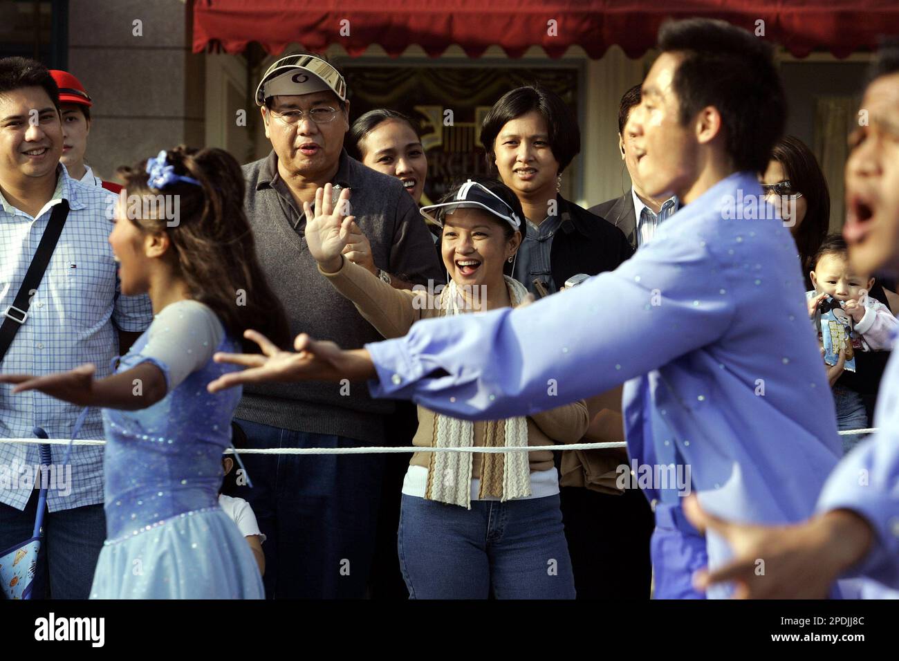 Philippine President Gloria Macapagal Arroyo, center, waves to ...