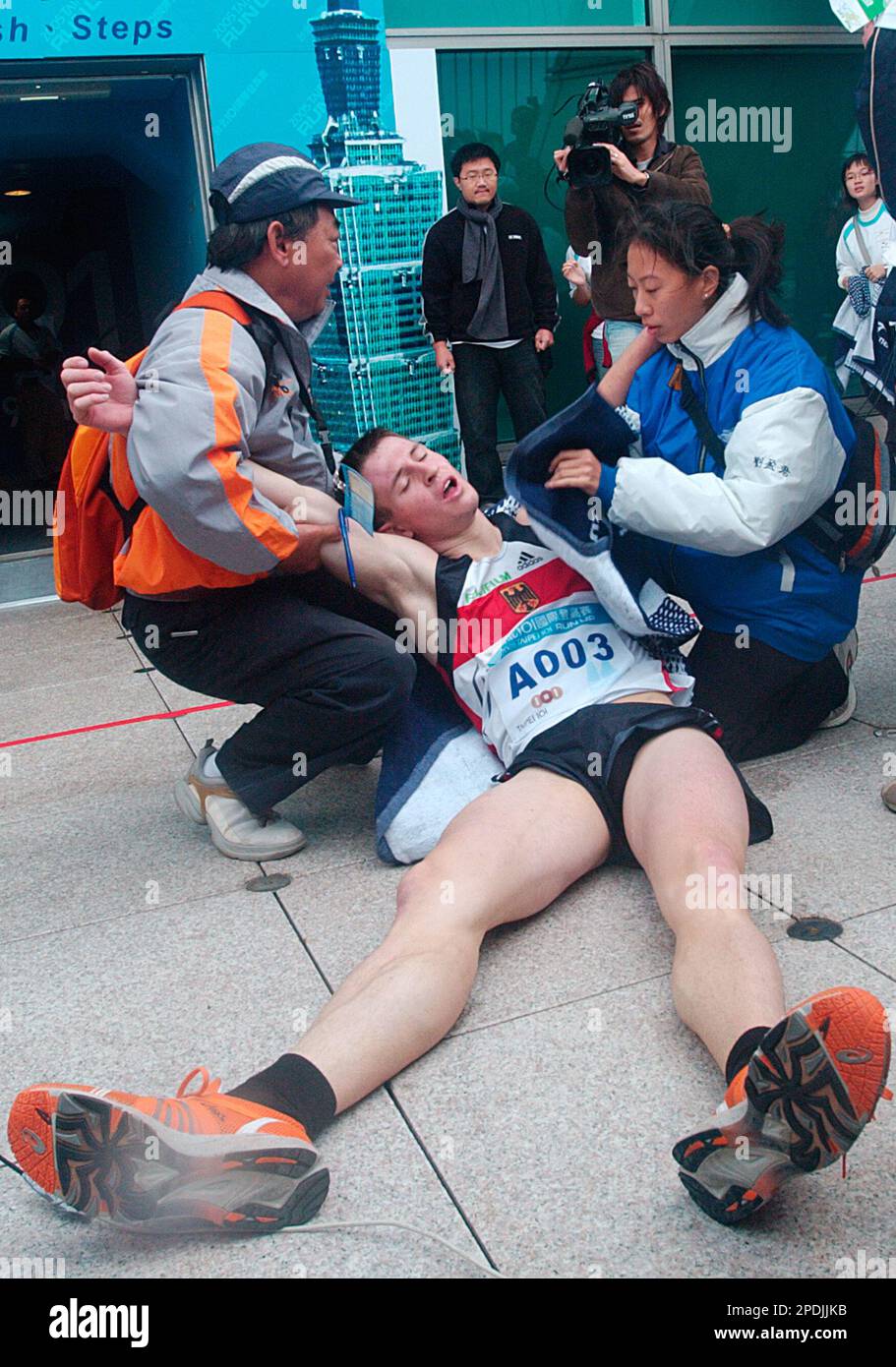 Poland's Jaroslaw Lazarowicz collapses after crossing the finish line ...