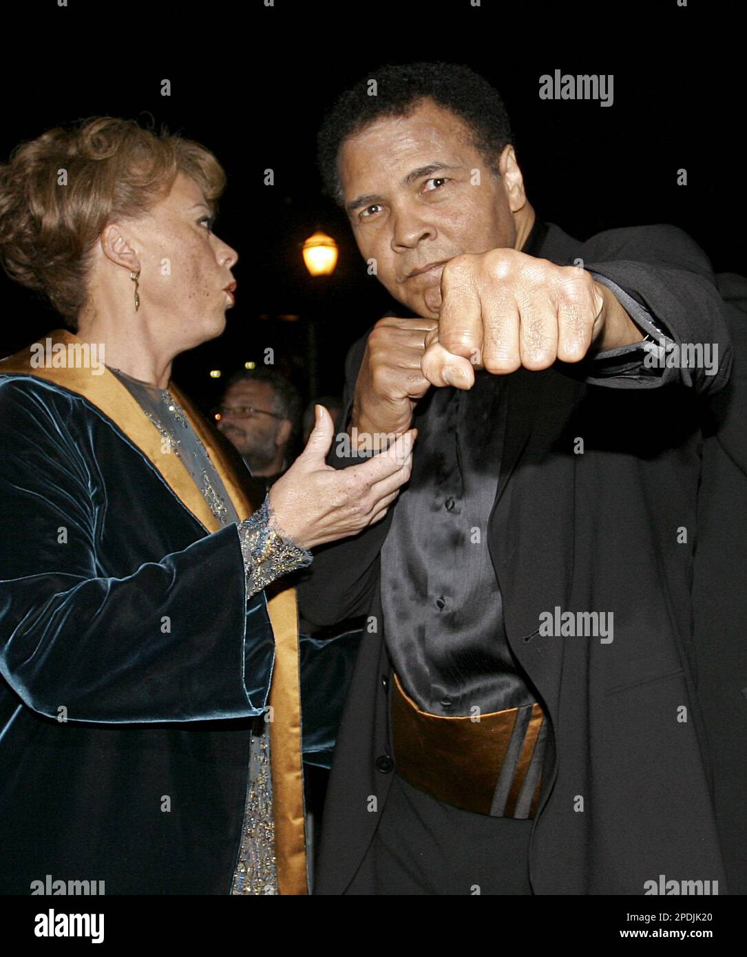 Muhammad Ali poses for the cameras as he and his wife, Lonnie, left ...