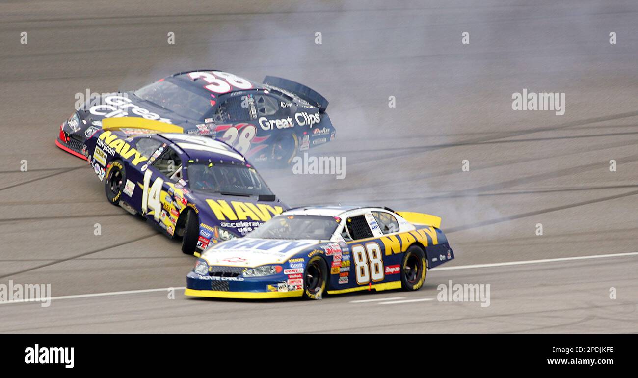 NASCAR driver David Stremme (14) slides between A.J. Foyt IV (38) and ...
