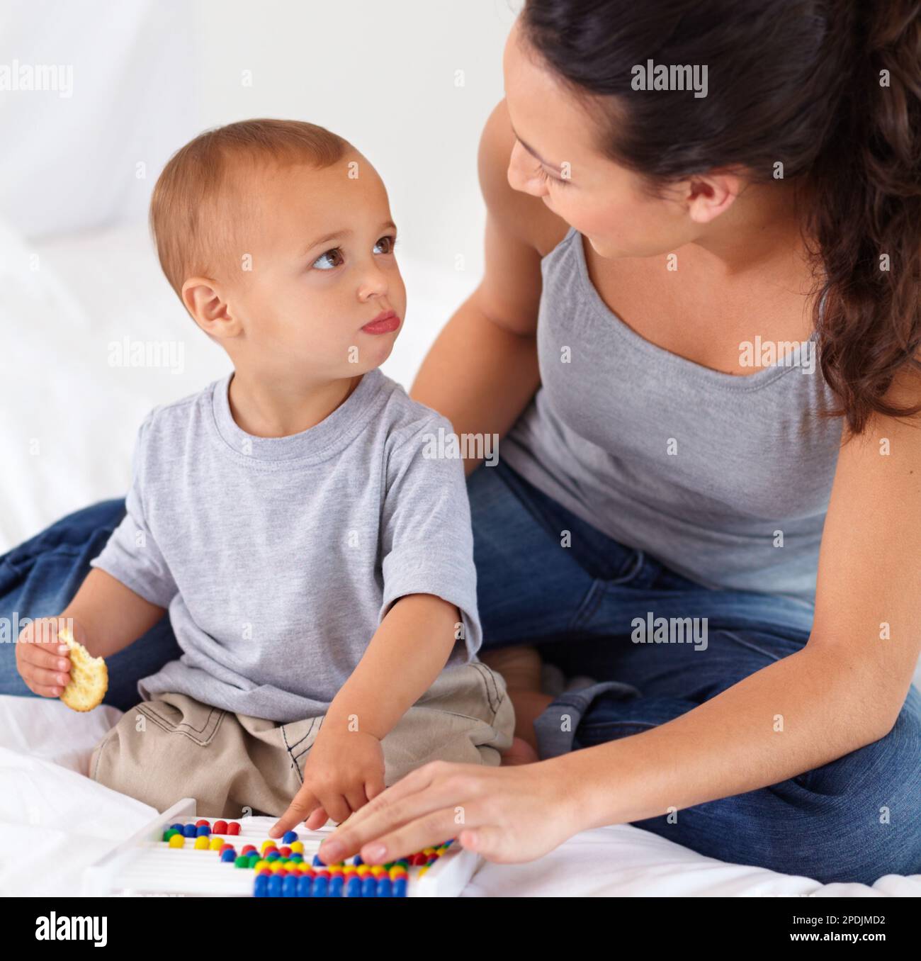 Eating a tasty cracker. An adorable little boy eating a cracker and ...