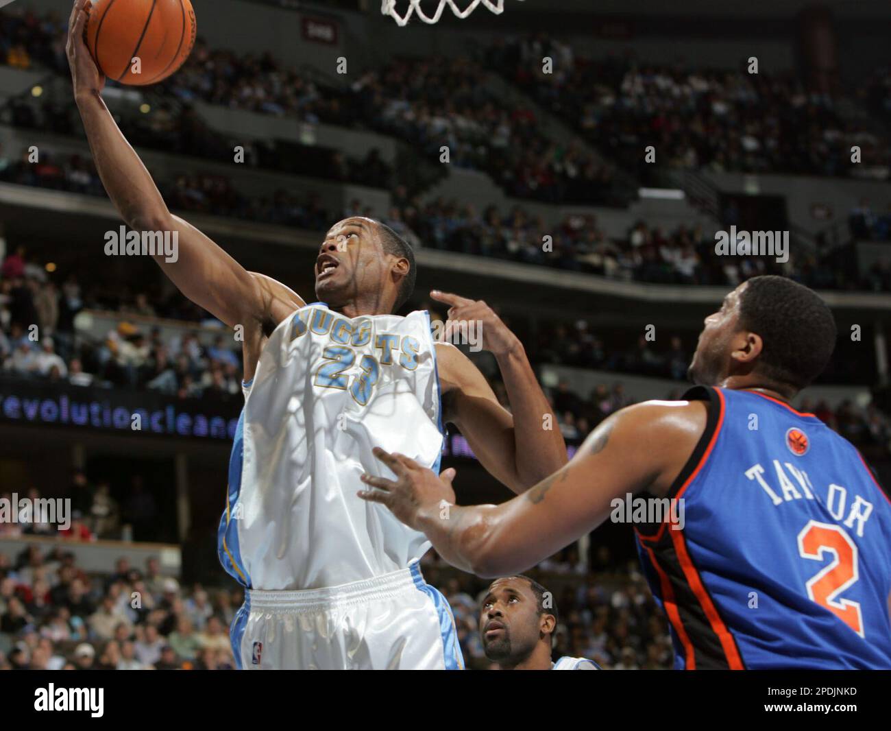 Denver Nuggets forward Marcus Camby, left, pulls in a rebound in front ...