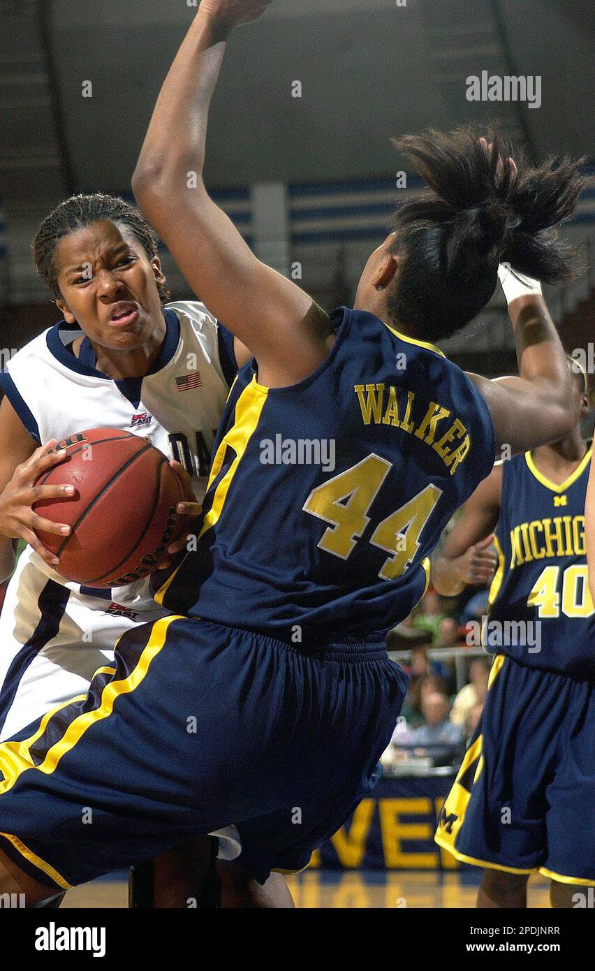 Notre Dame guard Charel Allen (2) collides with Michigan forward Ta ...