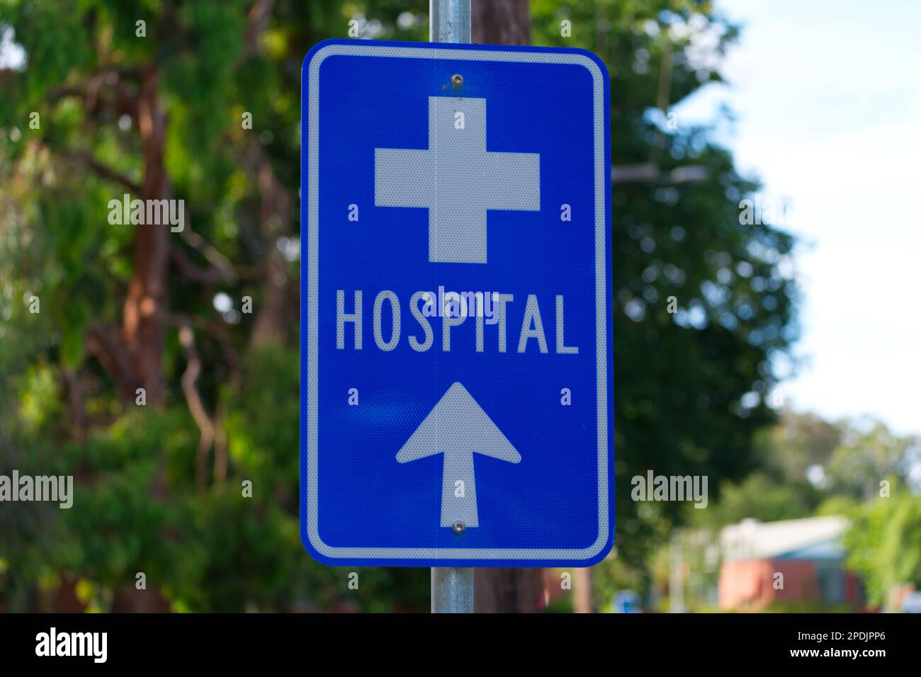 Blue and white hospital sign with arrow pointing to hospital ahead ...