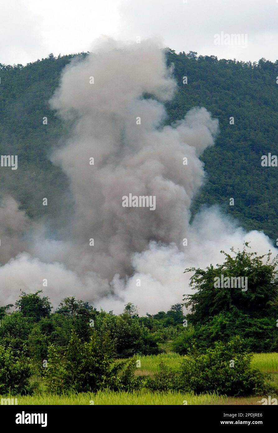 A huge cloud of smoke hangs in the air following a controlled explosion ...