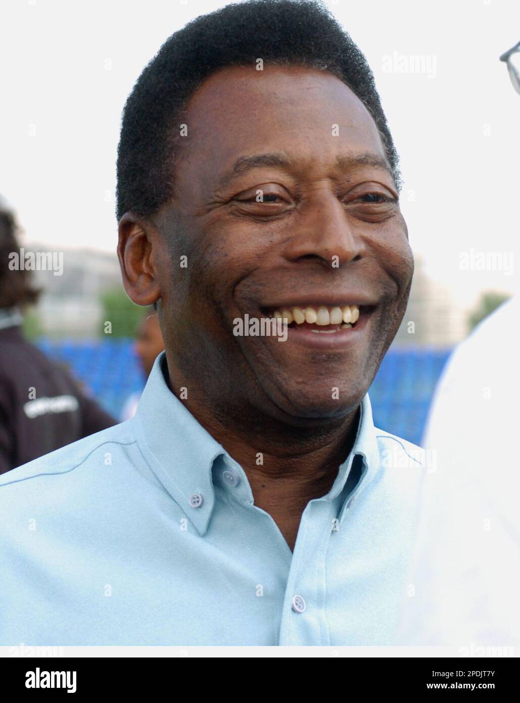 Brazilian soccer legend Pele smiles as he talks to children in Doha ...