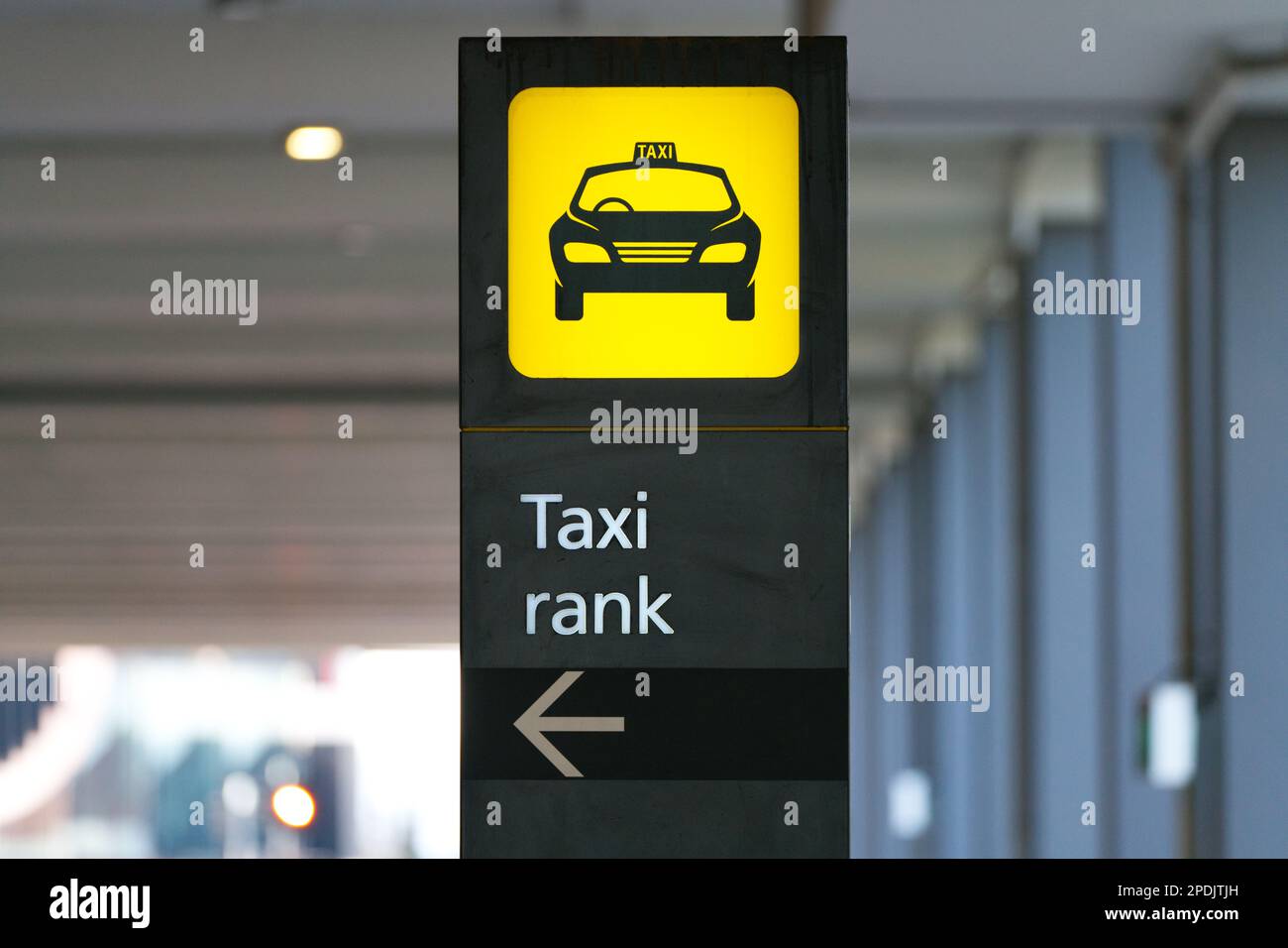 Graphic taxi rank sign with a yellow and black metal background, at Tullamarine airport ...