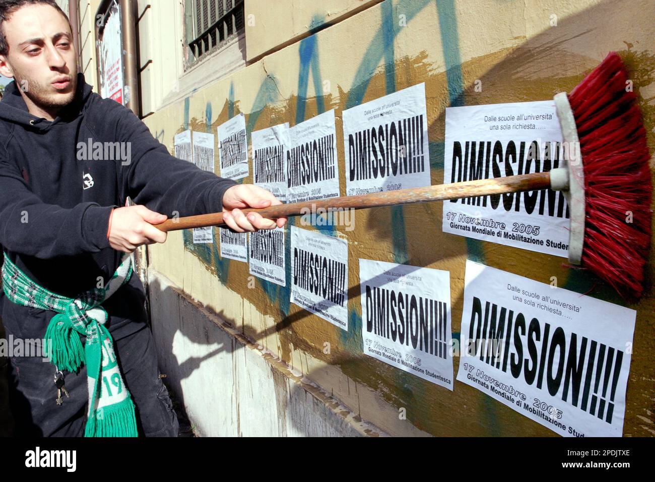 Students paste signs saying "Resign" aimed at Italian Education ...