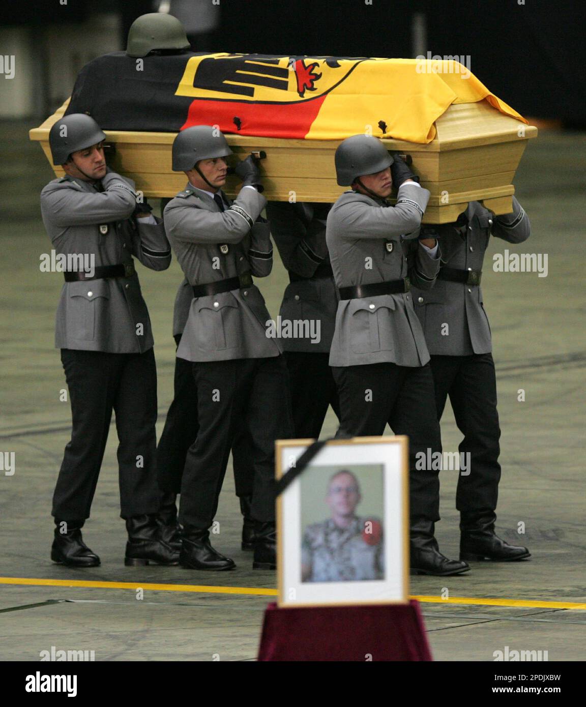 German soldiers carry the coffin of the German soldier, who died in a ...