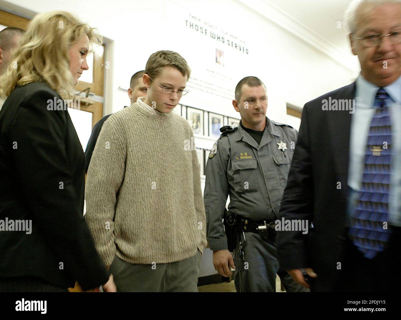 Shooting suspect Ken Bartley Jr., 14, center, is led out of the ...
