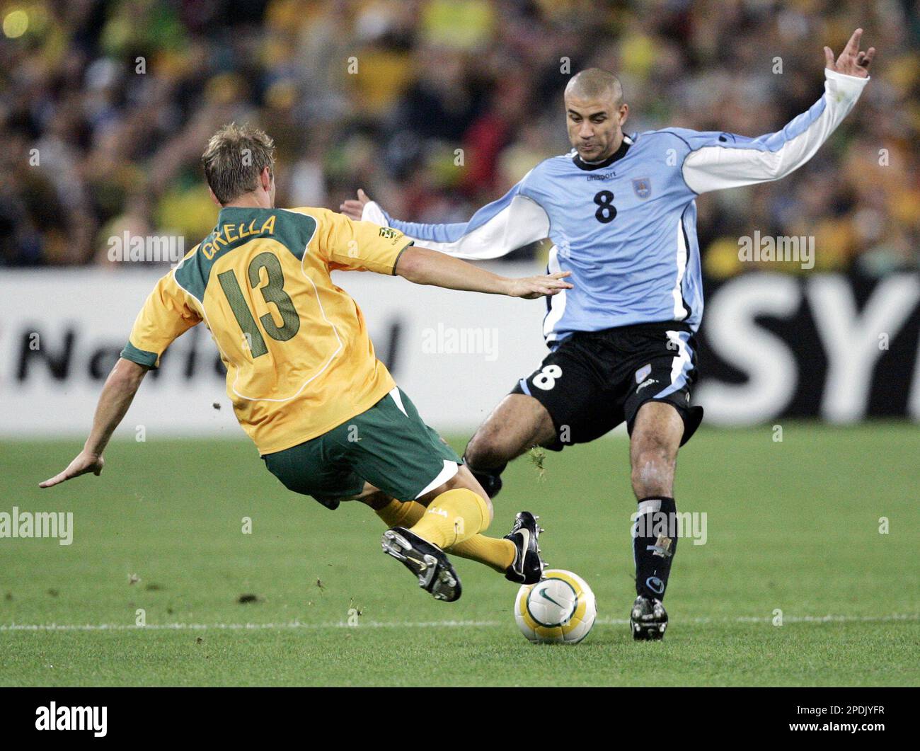 Australia's Vincent Grella, left, tackles Urguay's Gustavo Varella ...