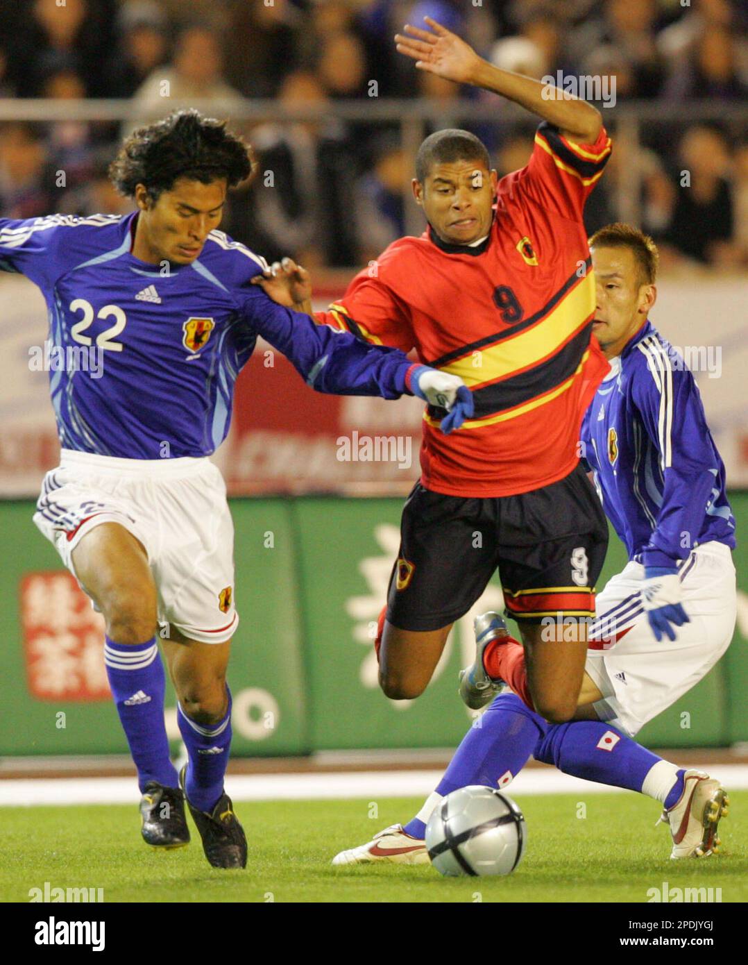 Edson of Angola national team, center, battles for the ball with Japan ...