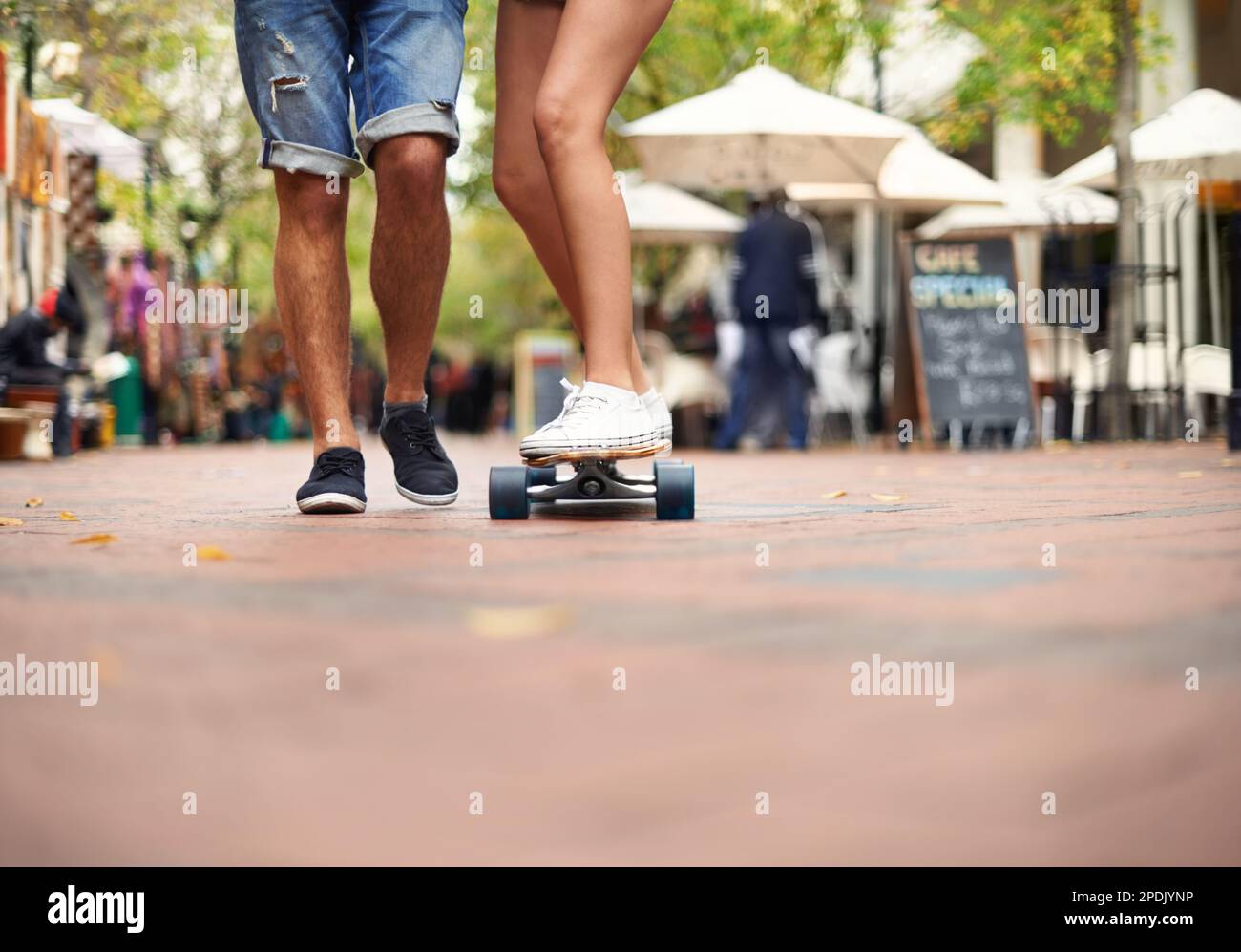 Taking it one ride at a time...a young couples legs with one balancing ...