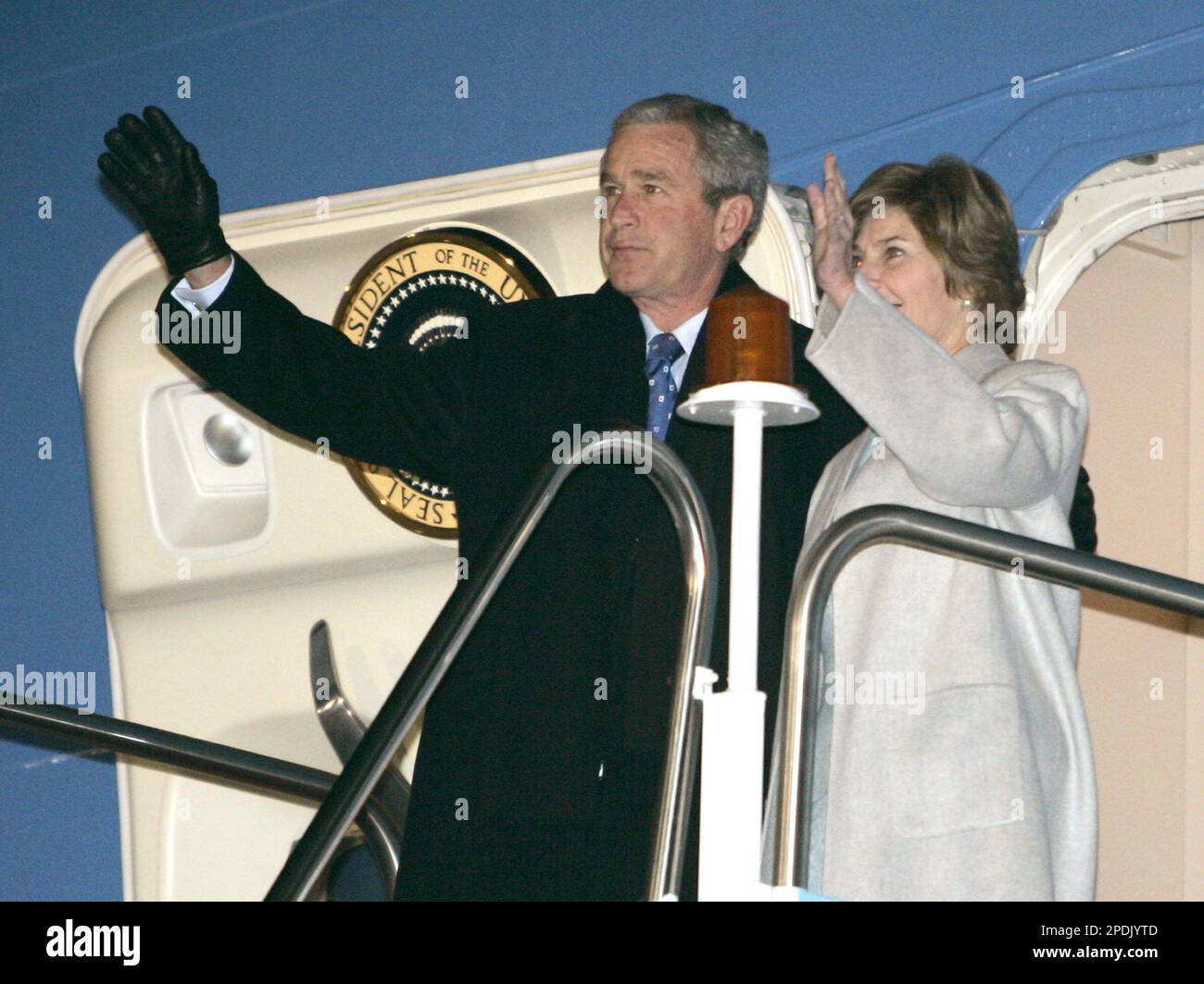 U.S. President George W. Bush, left and first lady Laura Bush step off ...