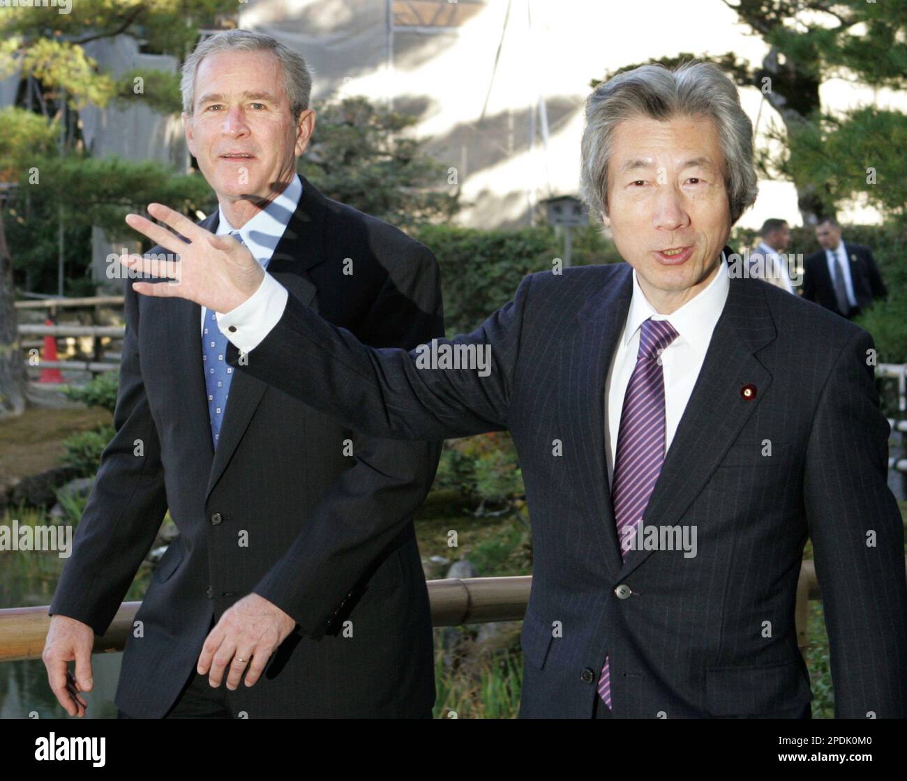 U.S. President George W. Bush, left, is escorted by Japanese Prime ...