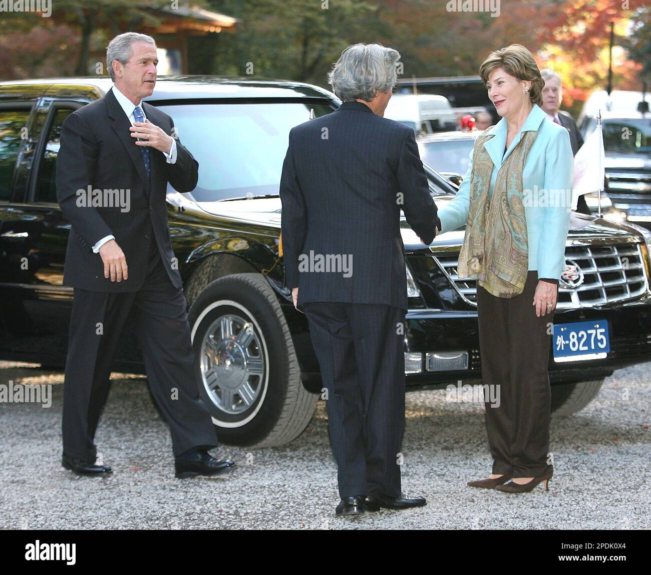 U.S. President George W. Bush and First Lady Laura Bush are welcomed by ...