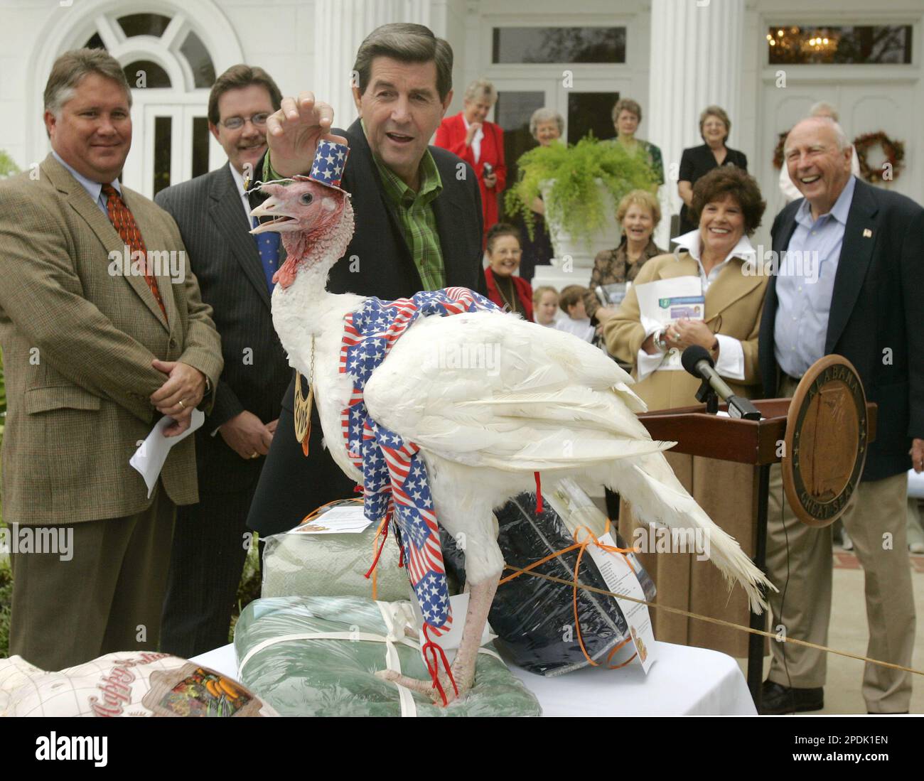 Alabama Gov. Bob Riley adjusts the hat on a turkey named "Clyde" before ...