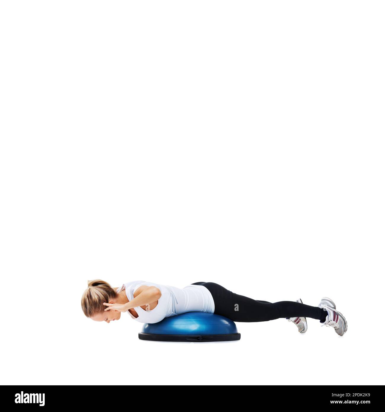 Building her stomach muscles. A young woman strengthening her core on a ...