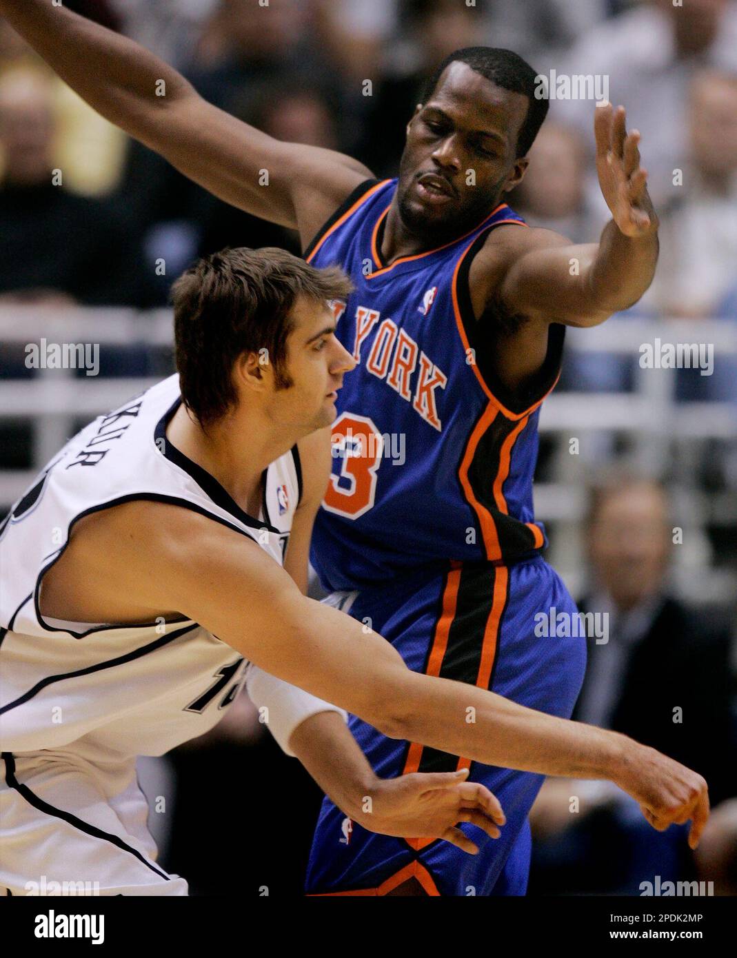 Utah Jazz forward Mehmet Okur, of Turkey, is forced to pass the ball by ...
