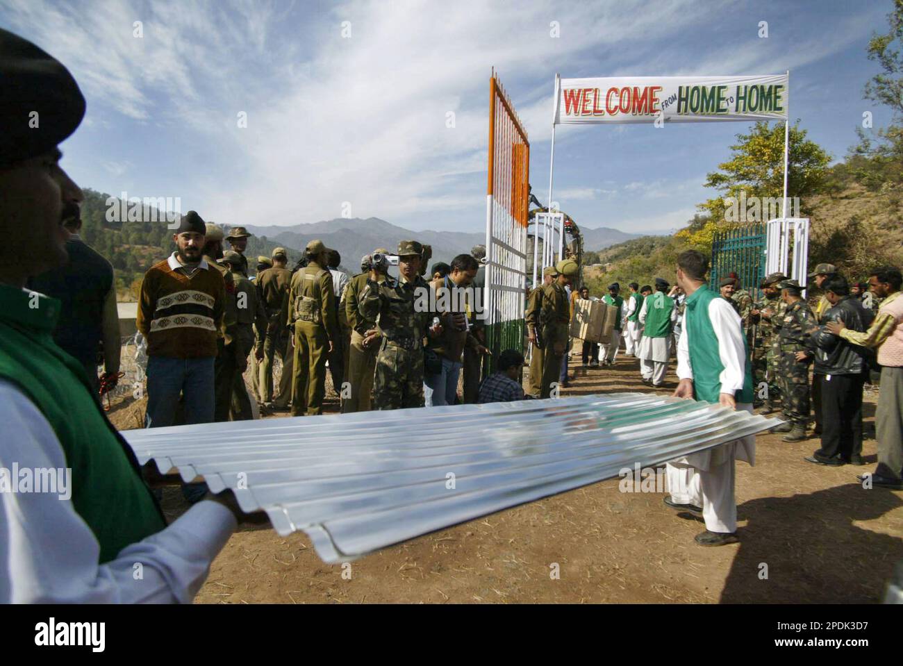 Pakistani porters carry roofing sheets to be provided as relief for ...